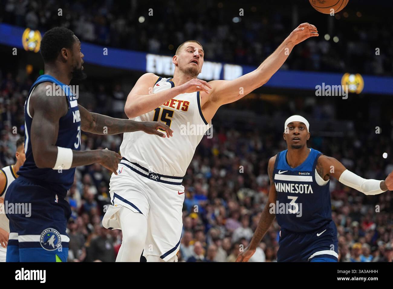 Denver Nuggets center Nikola Jokic (15) drives between Minnesota ...
