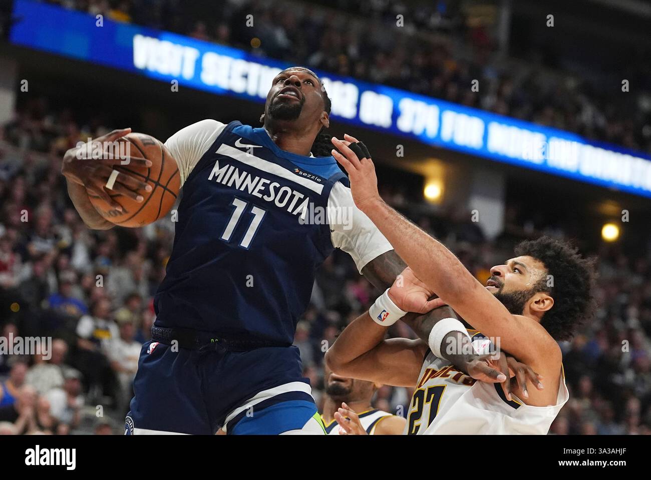 Minnesota Timberwolves center Naz Reid (11) and Denver Nuggets guard ...