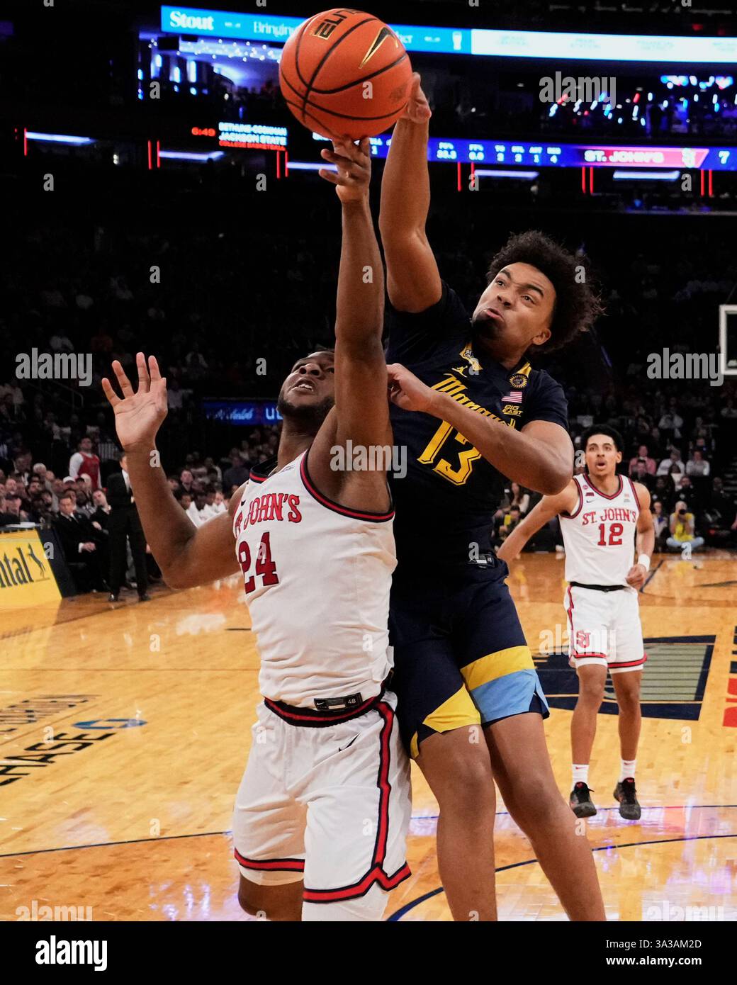Marquette's Royce Parham (13) fights for control of the ball with St ...