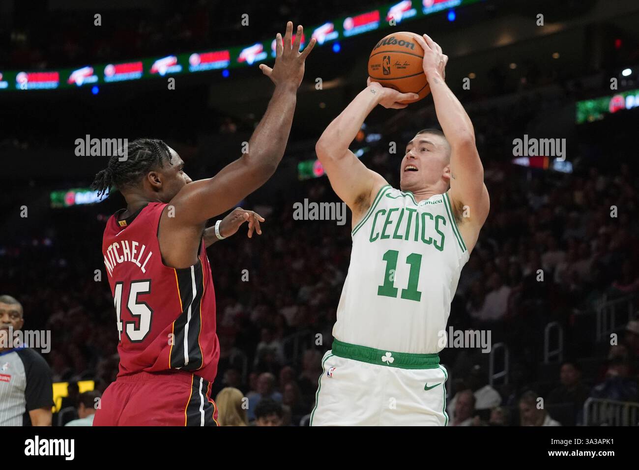 Boston Celtics guard Payton Pritchard (11) aims to score as Miami Heat guard Davion Mitchell (45 ...