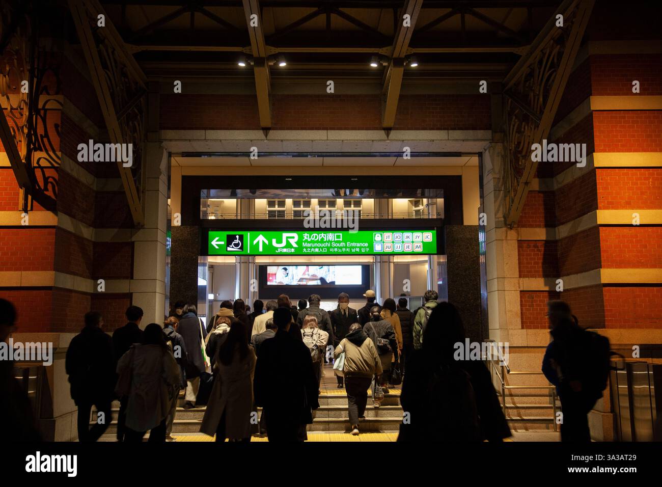 Scene at Tokyo Station with people exiting the Marunouchi South Entrance of the station Stock ...