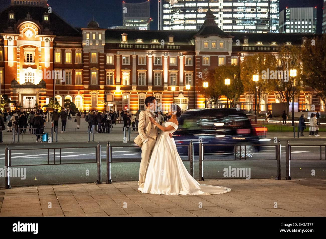 Pre-wedding photos taken at night outside Tokyo Station in Japan Stock ...