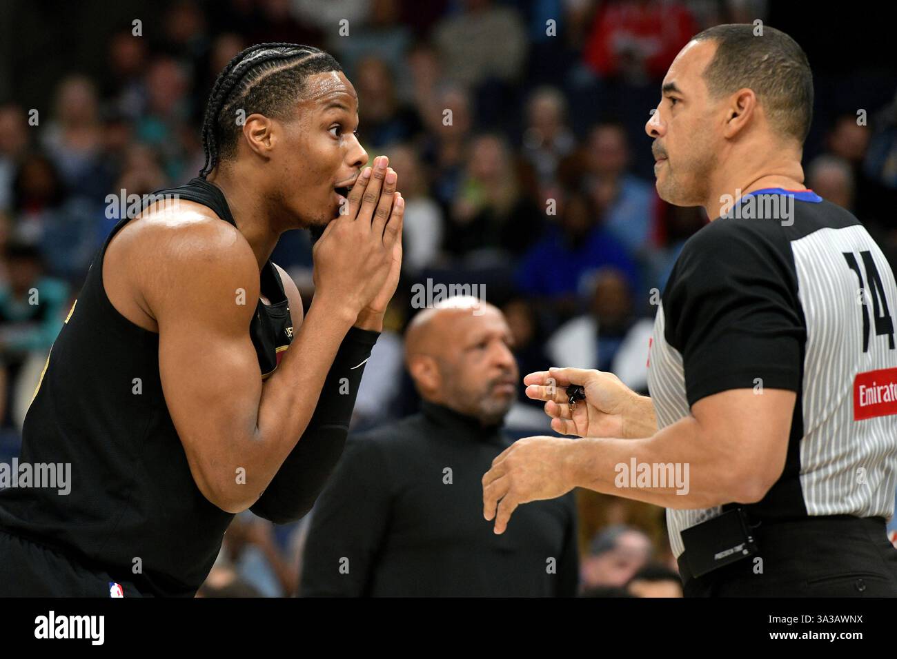 Cleveland Cavaliers forward Isaac Okoro, left, reacts to a call by ...