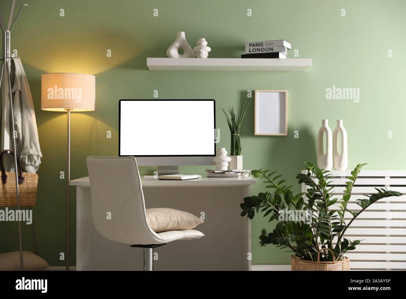 Comfortable workplace at home. Computer monitor with blank white screen ...