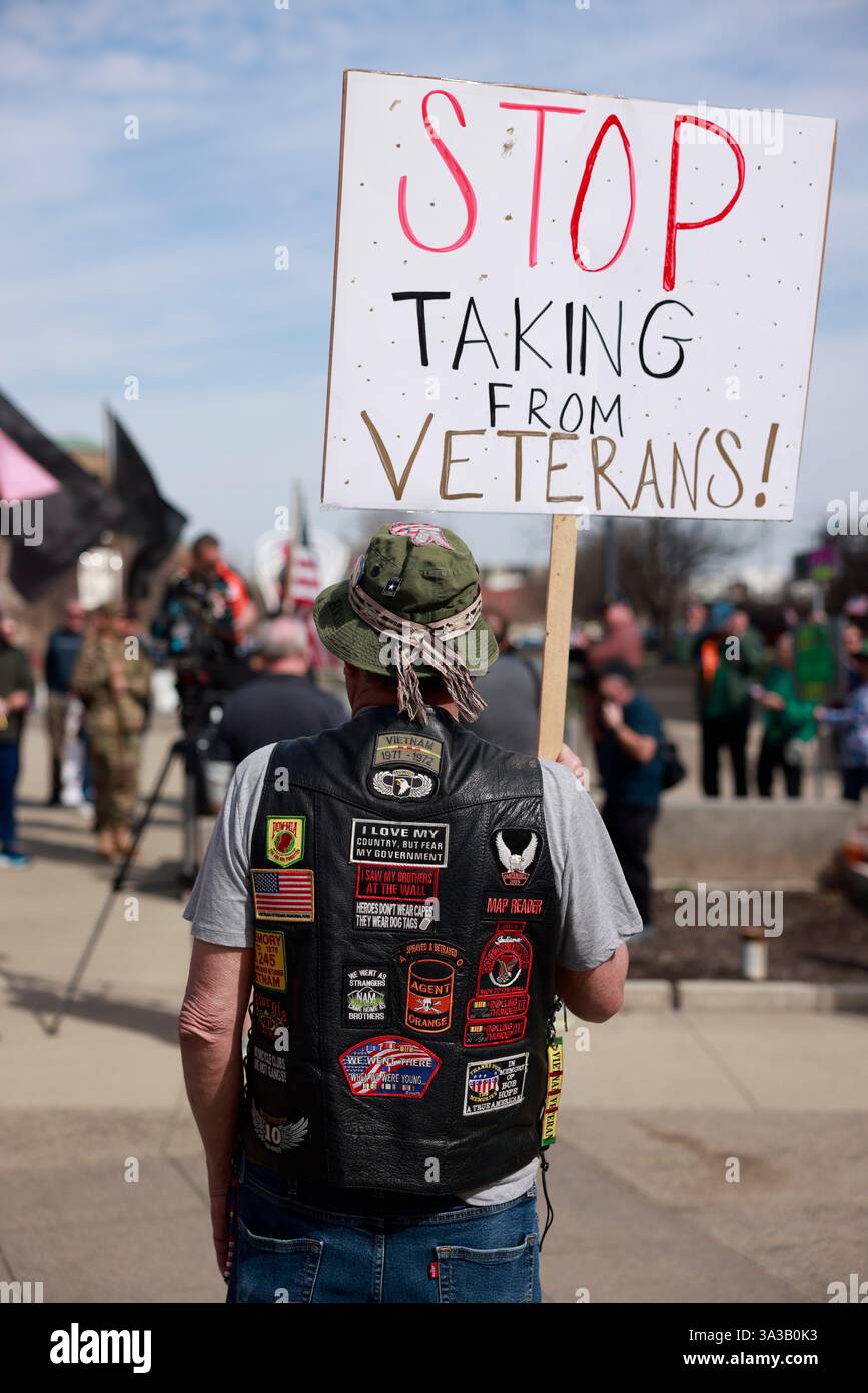 INDIANAPOLIS, INDIANA - MARCH 14: A protester holds a sign reading ...