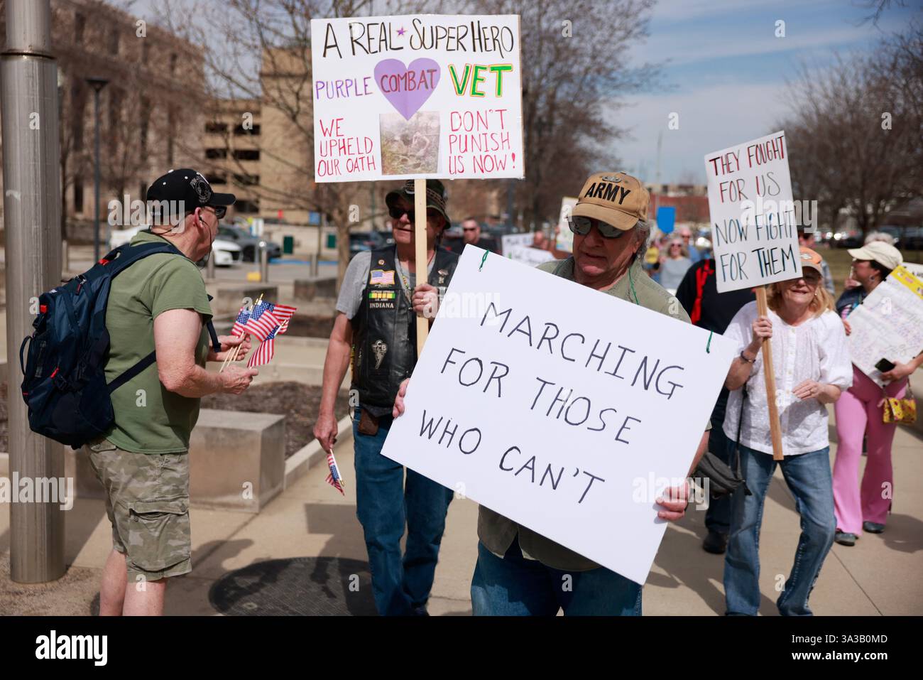 INDIANAPOLIS, INDIANA - MARCH 14: A protester carries a sign reading ...