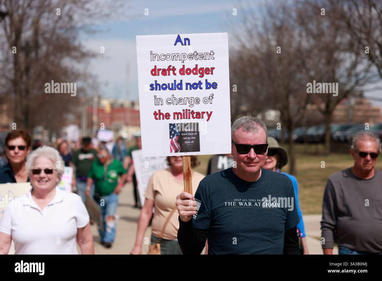 INDIANAPOLIS, INDIANA - MARCH 14: A protester carries a sign reading ...