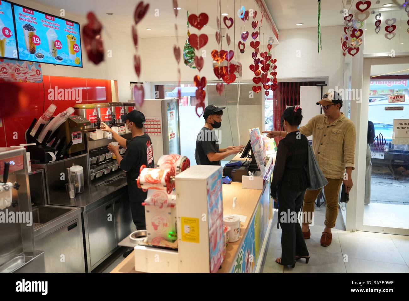 A costumer orders a drink at a Mixue store in Jakarta, Indonesia ...