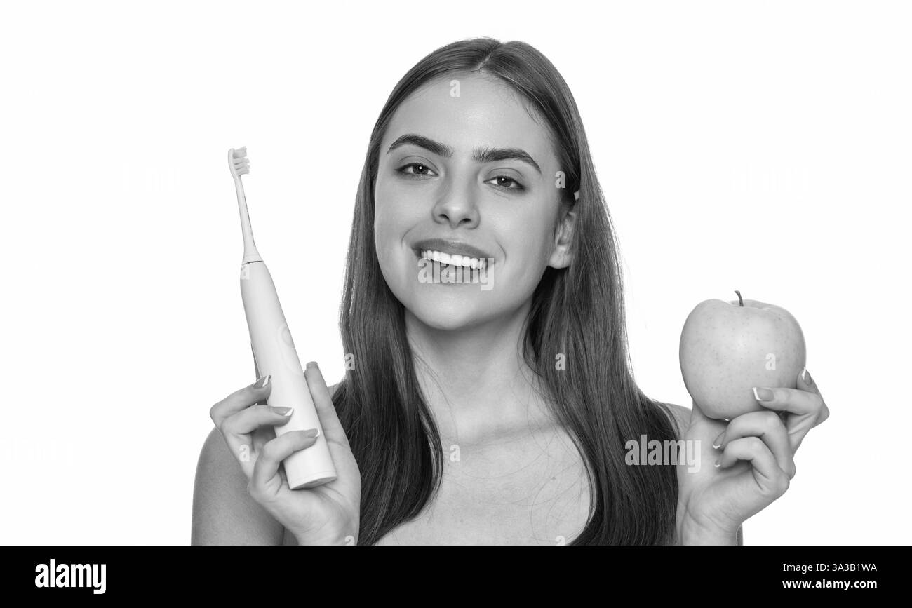 Woman with white smile brushing teeth with electric toothbrush hold ...