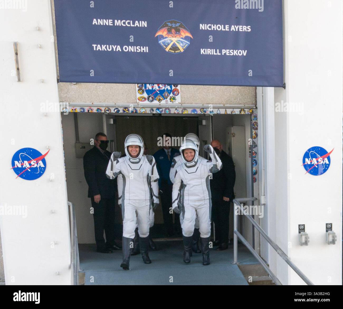 Excitehed astronauts walking out of the Neil Armstrong O & C Building ...