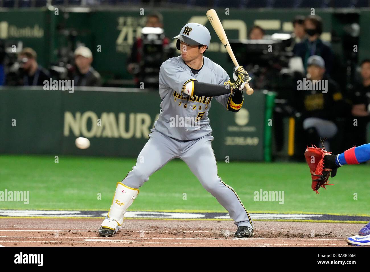 Hanshin Tigers' Koji Chikamoto bats against the Chicago Cubs during the ...