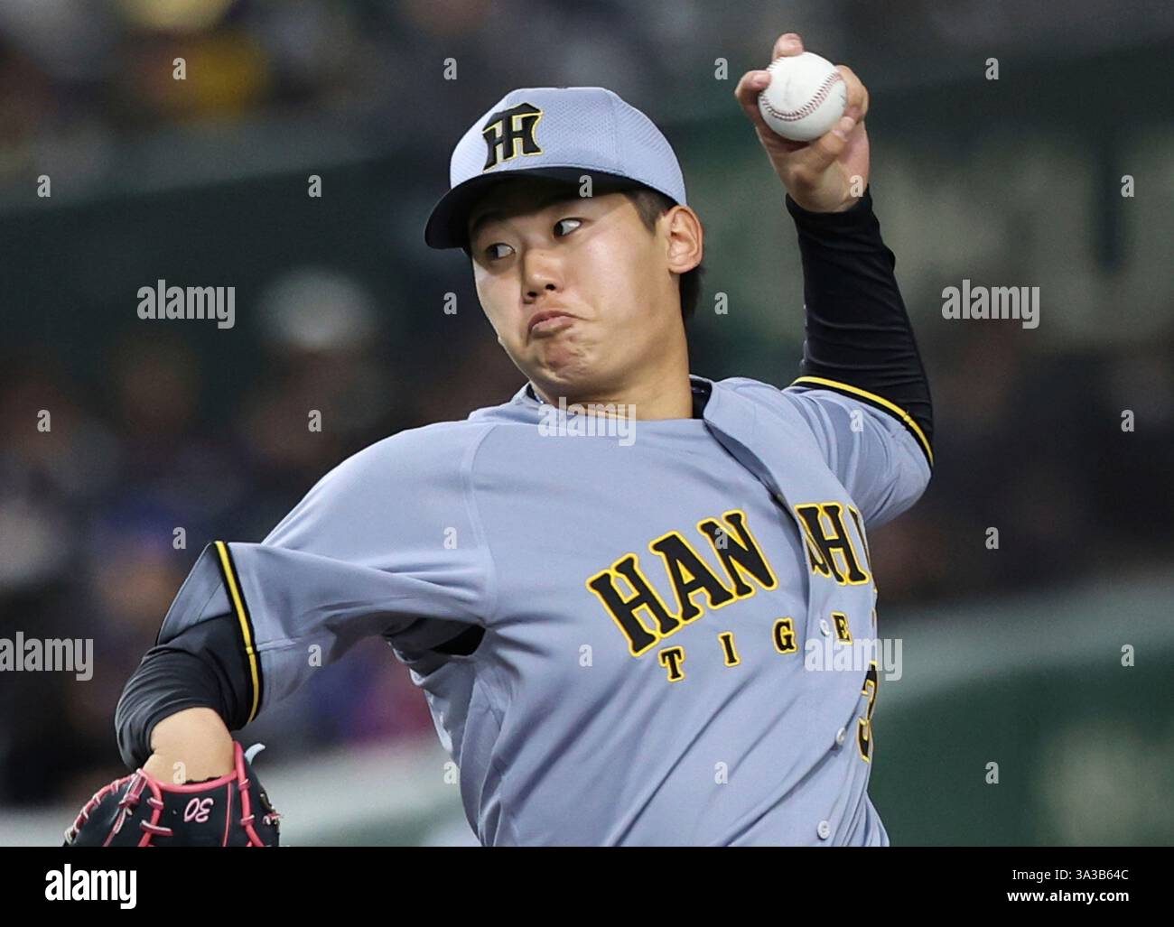Hanshin Tigers starting pitcher Keito Monbetsu pitches in the first ...