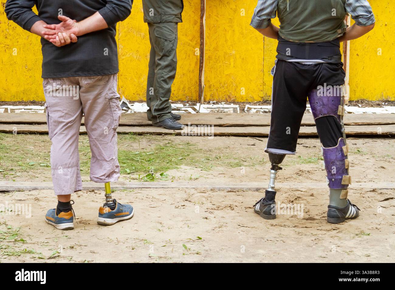 Sports and people with disabilities. A man without a leg throws knives ...