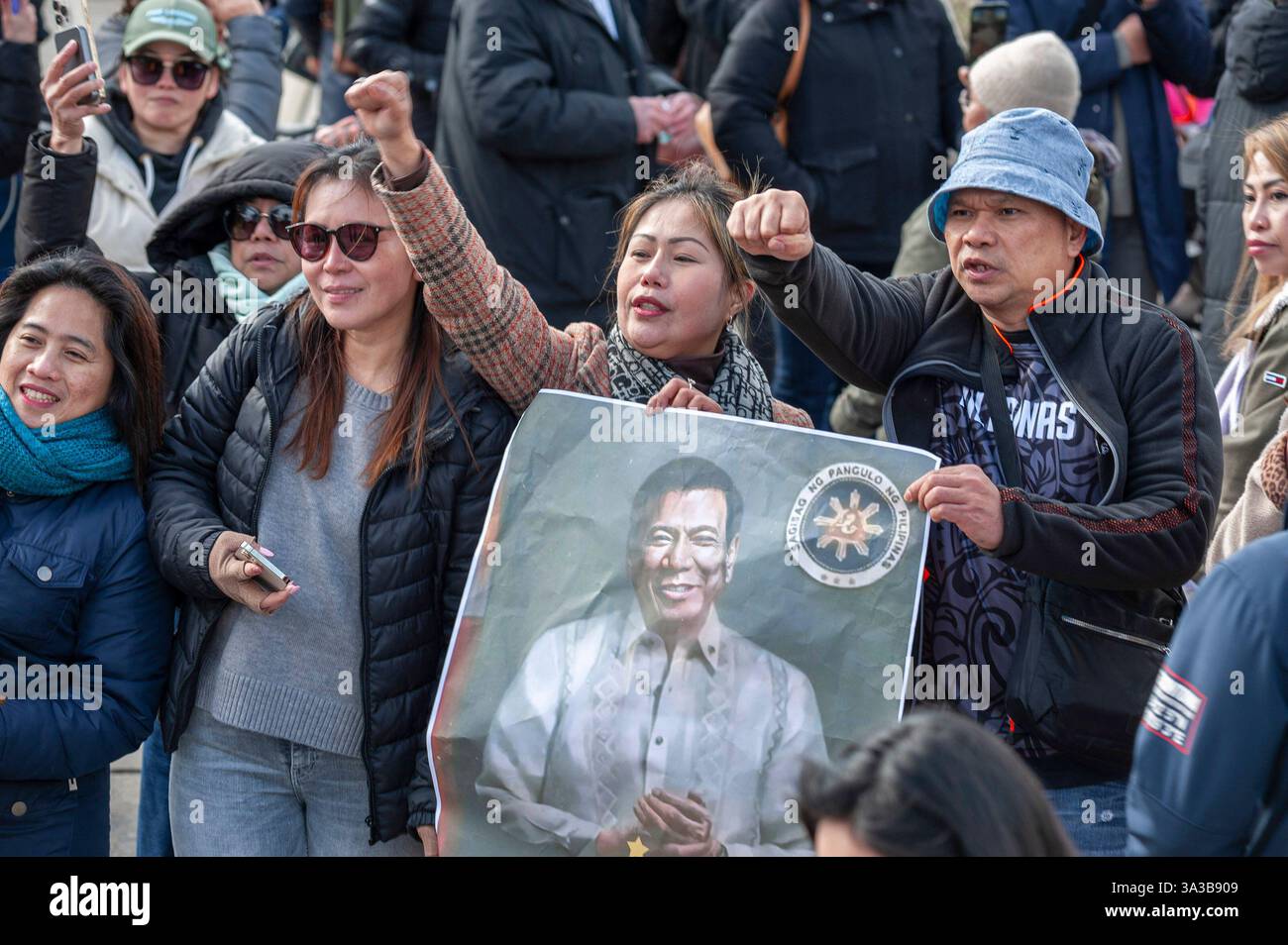 Supporter of ex-president Duterte, holds a large poster of the ex ...