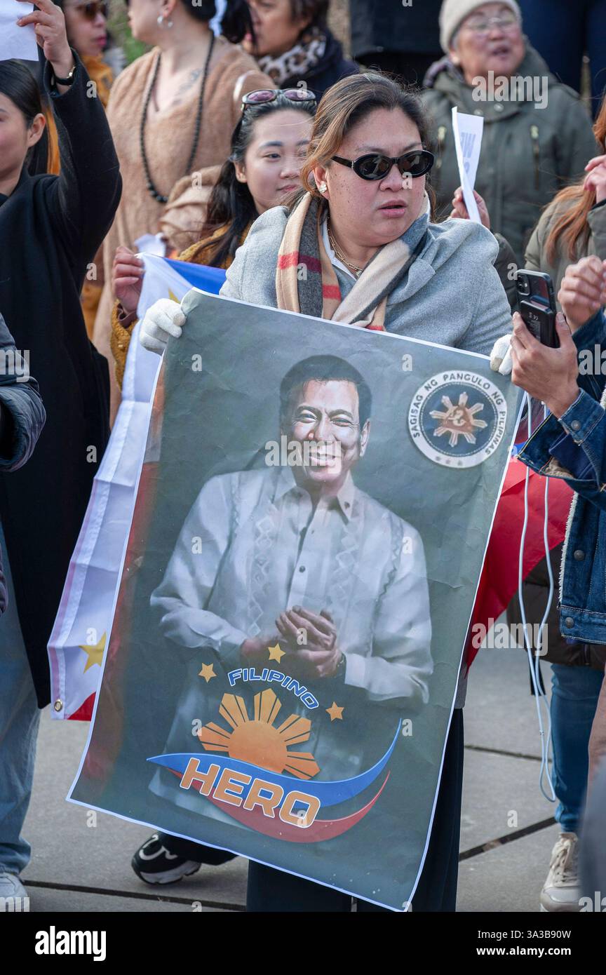 Supporter of ex-president Duterte, holds a large poster of the ex ...