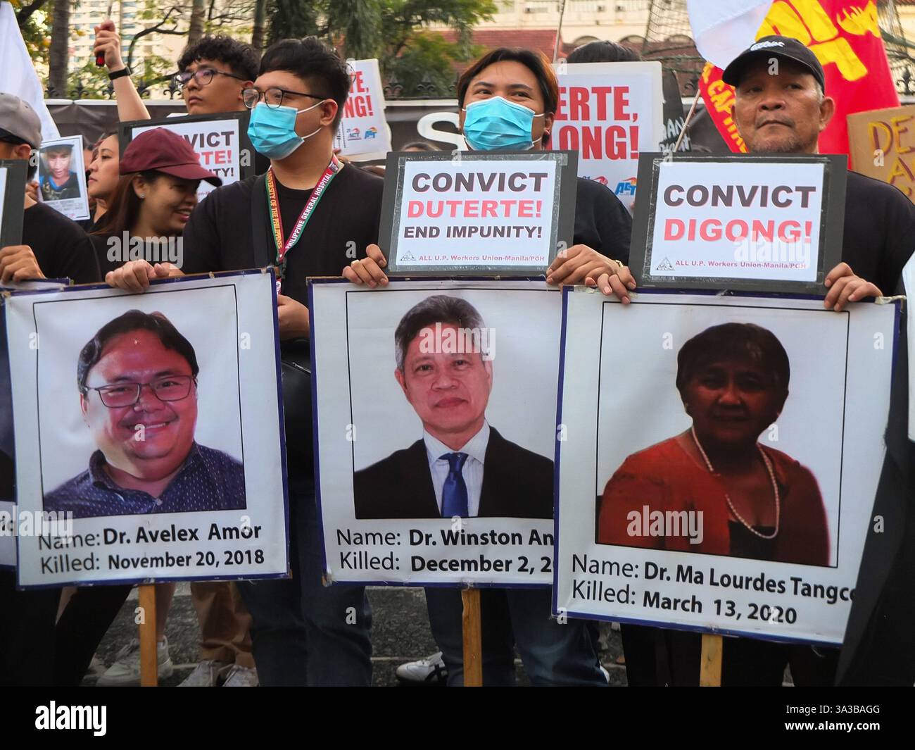 Protesters display photos of their slain family members during the ...