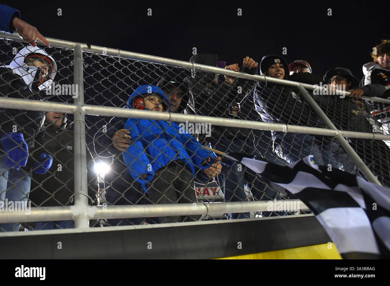 LAS VEGAS, NV - MARCH 14: The race official hands a young fan the ...
