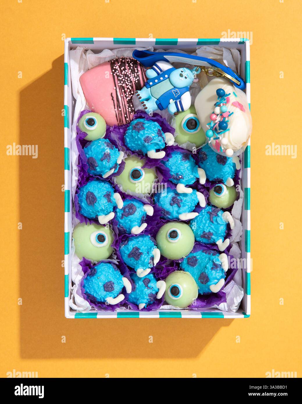 Charming gift box overflowing with Monsters Inc. inspired cake pops, a ...