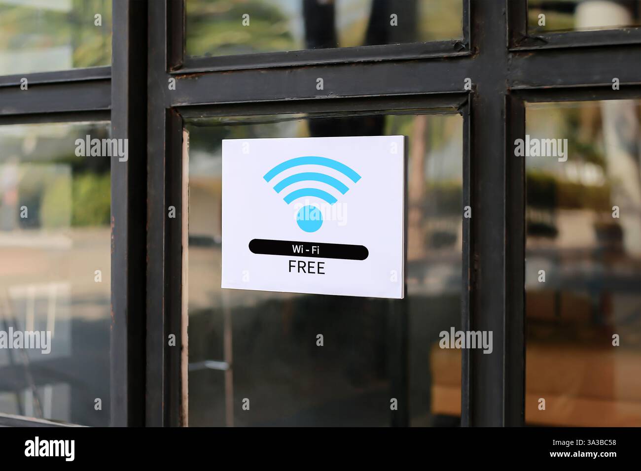 Free Wifi sign at the front entrance of the coffee shop to serve ...