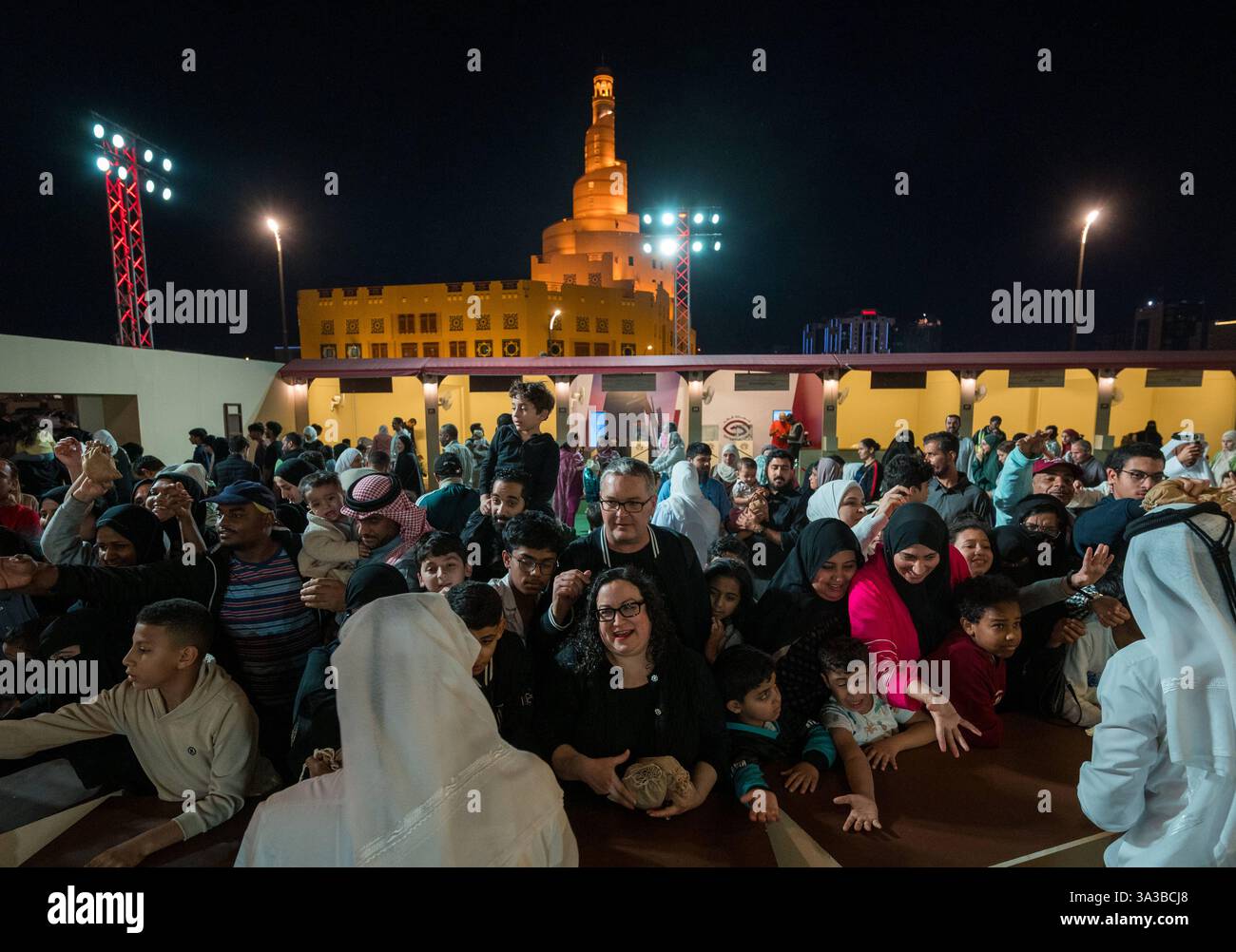 Doha Ramadan Garangao Festival 2025 A man is distributing bags of ...