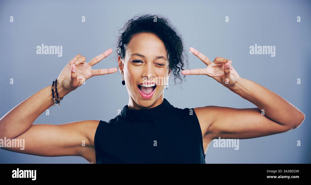 Studio, woman and portrait with wink for peace sign, support and ...