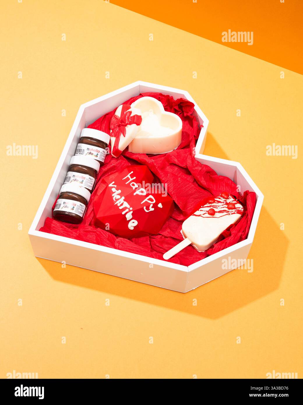 Heart shaped breakable chocolate box with Nutella jars and white ...