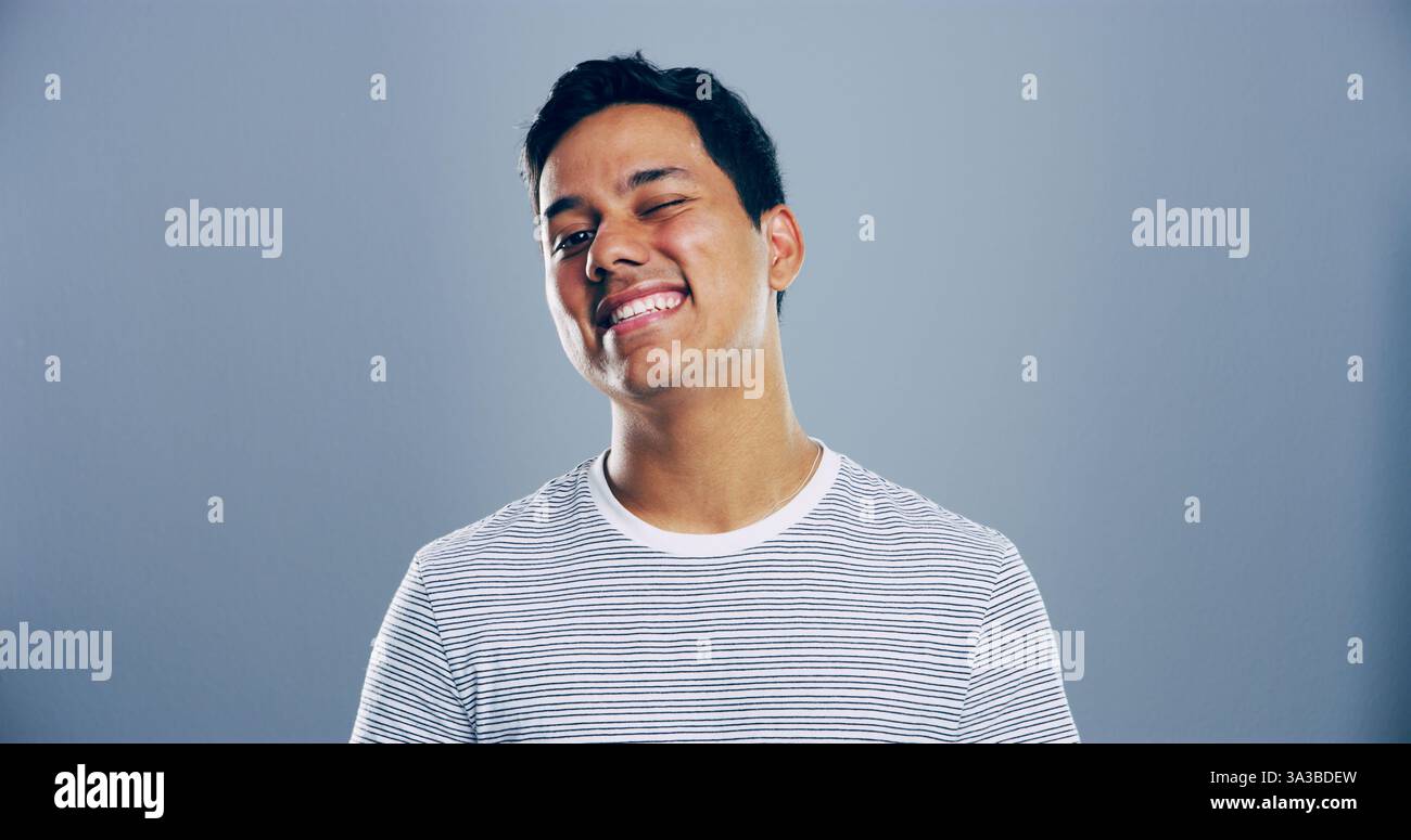 Man, happy and space with wink in studio portrait, sign and emoji for ...