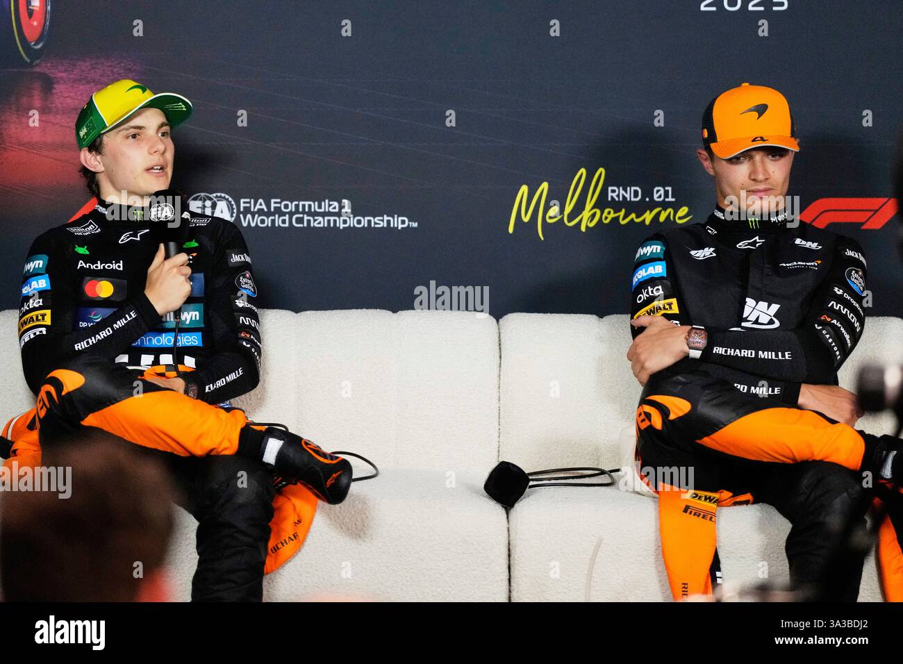 McLaren driver Oscar Piastri, left, of Australia speaks at a press conference after taking ...