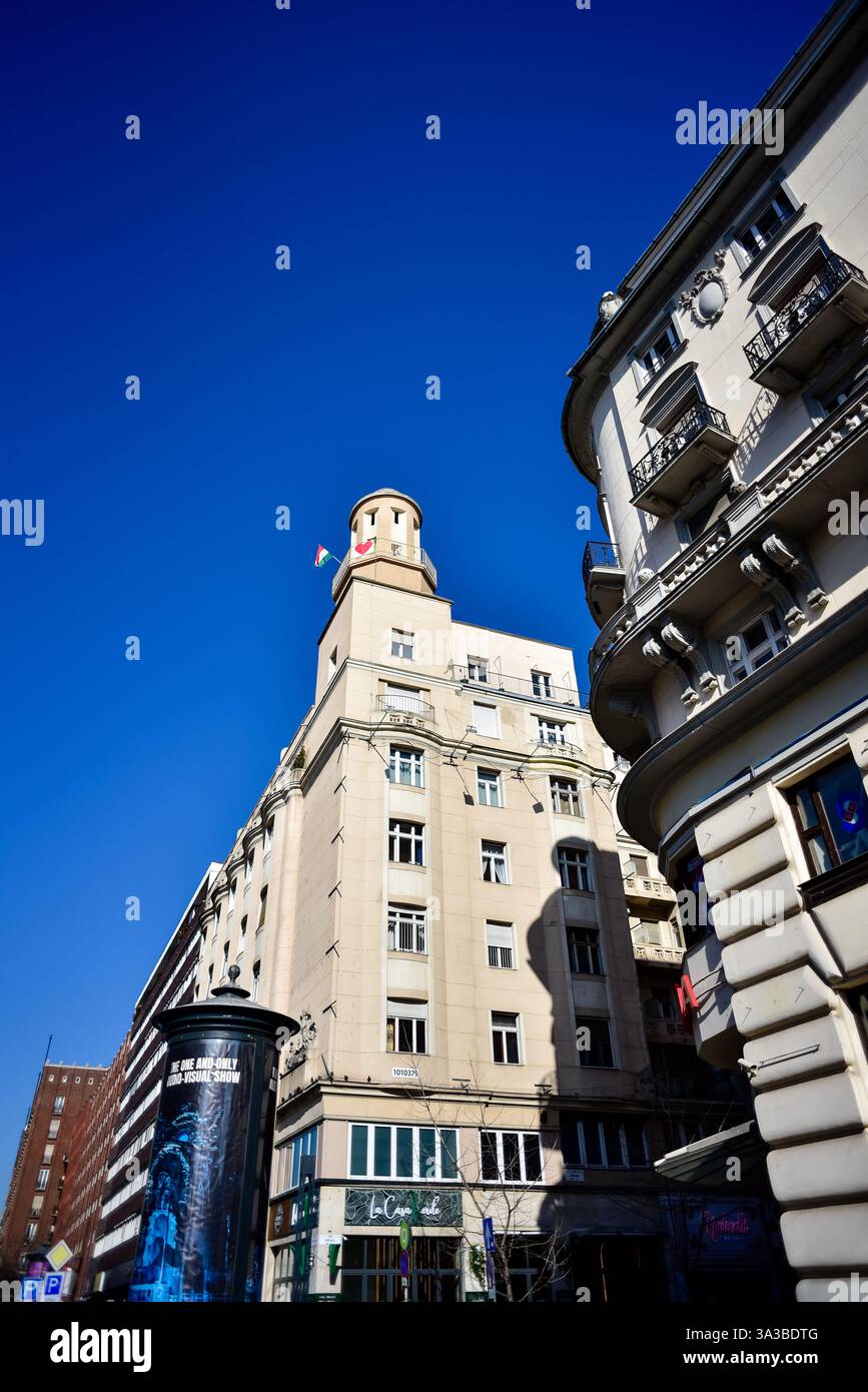 Historic buildings in Budapest stand tall against a vivid blue sky ...