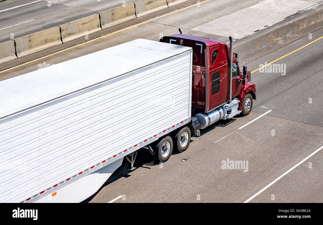 Industrial burgundy big rig long haul semi truck with extended cab for ...