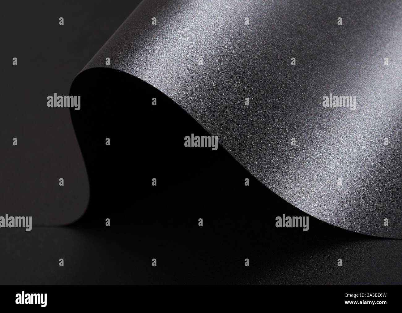 Black paper background with a smooth, glossy texture and metallic ...