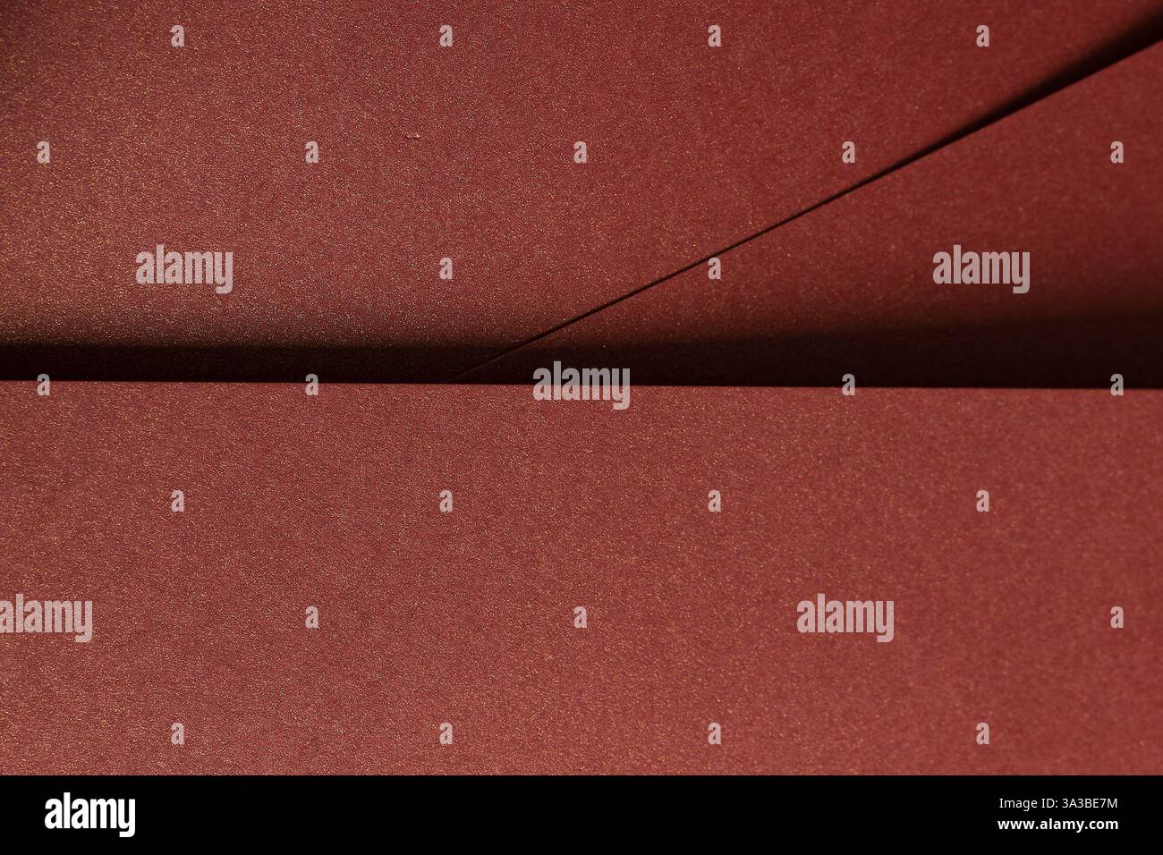 Burgundy paper background with a smooth texture and a metallic, glossy ...