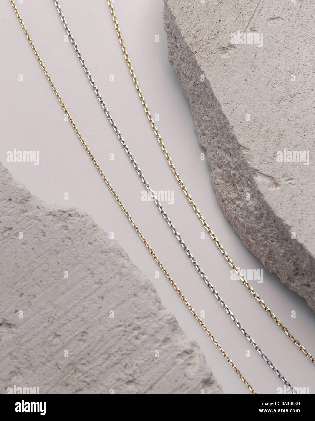 Trio of delicate cable chains in gold, silver, and rose gold on a ...