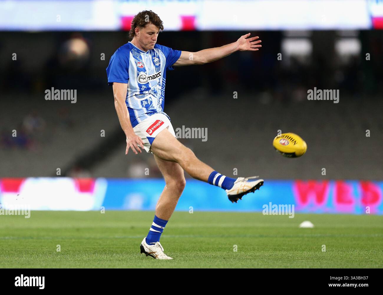 Nick Larkey of the Kangaroos kicks the ball during warm up prior to the ...