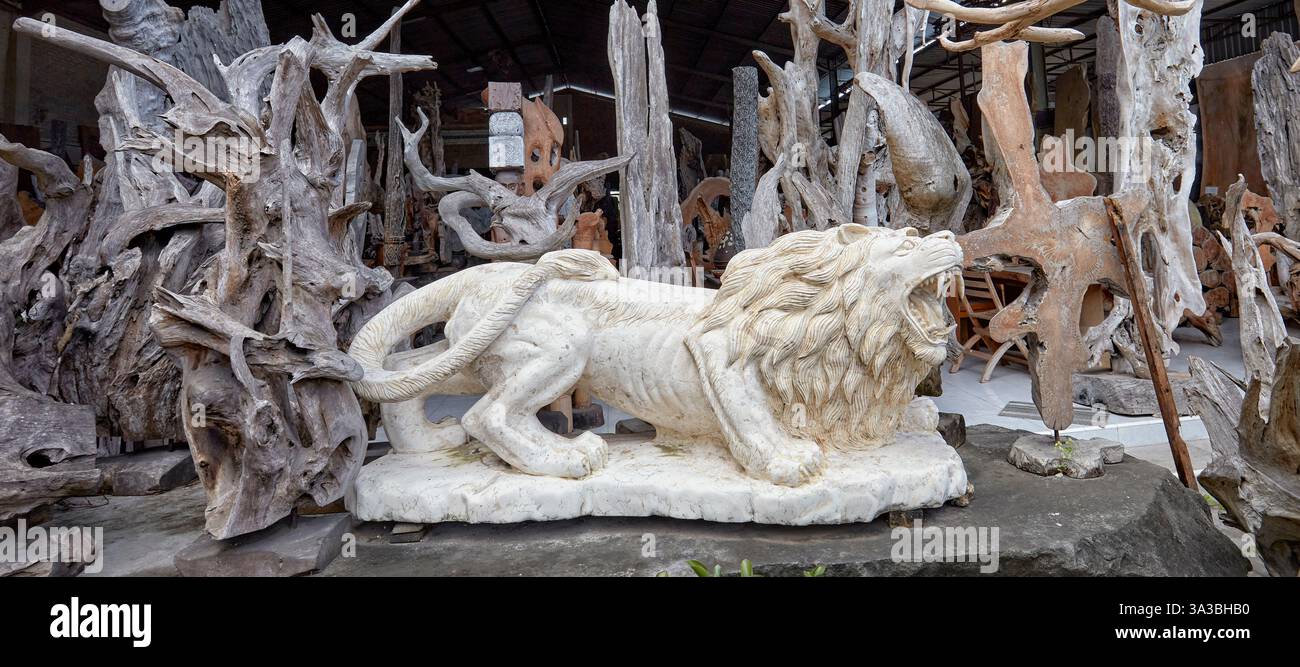 Wooden lion statue displayed at a millwork shop in Ubud, Bali ...
