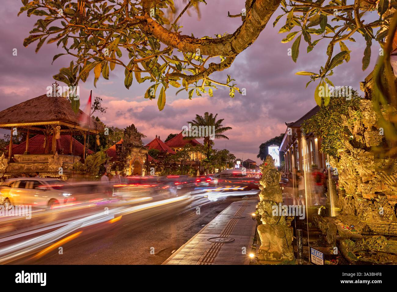 View of the Jalan Raya Ubud street with light trails of moving cars at ...