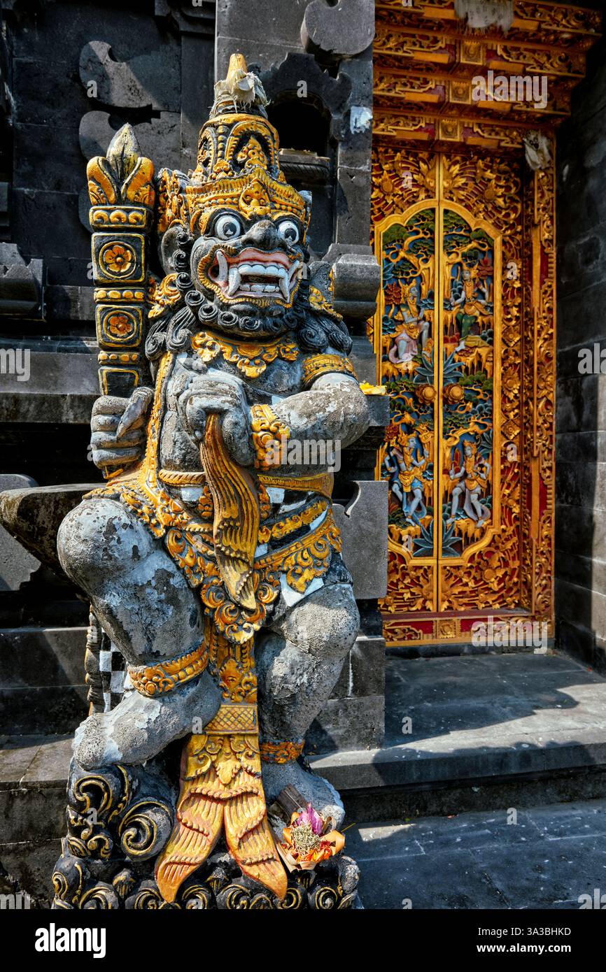 Intricately carved stone statue of a guardian at Batu Mejan Temple ...