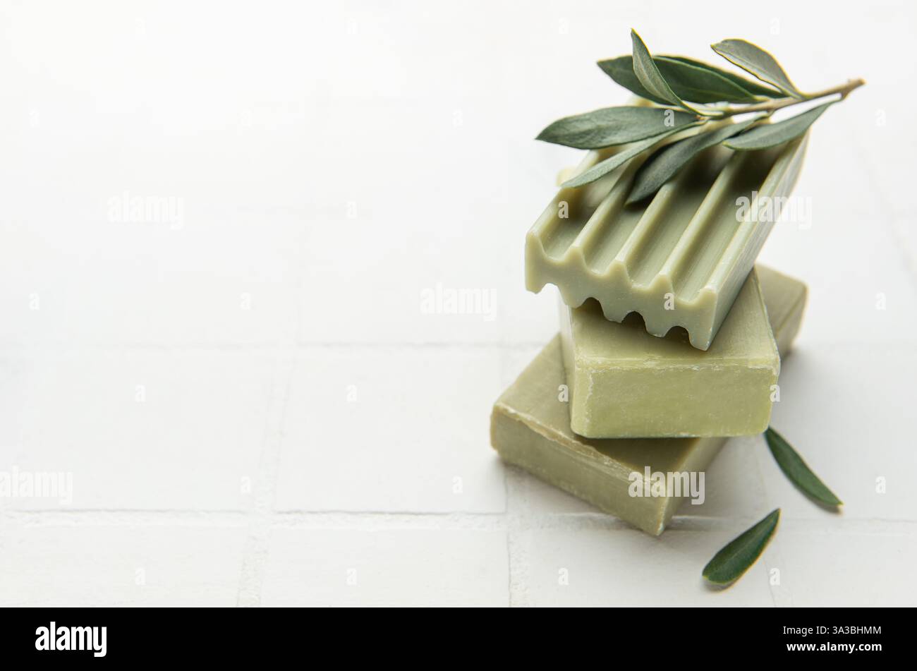 Natural olive soap bars forming a stack with an olive branch on top ...