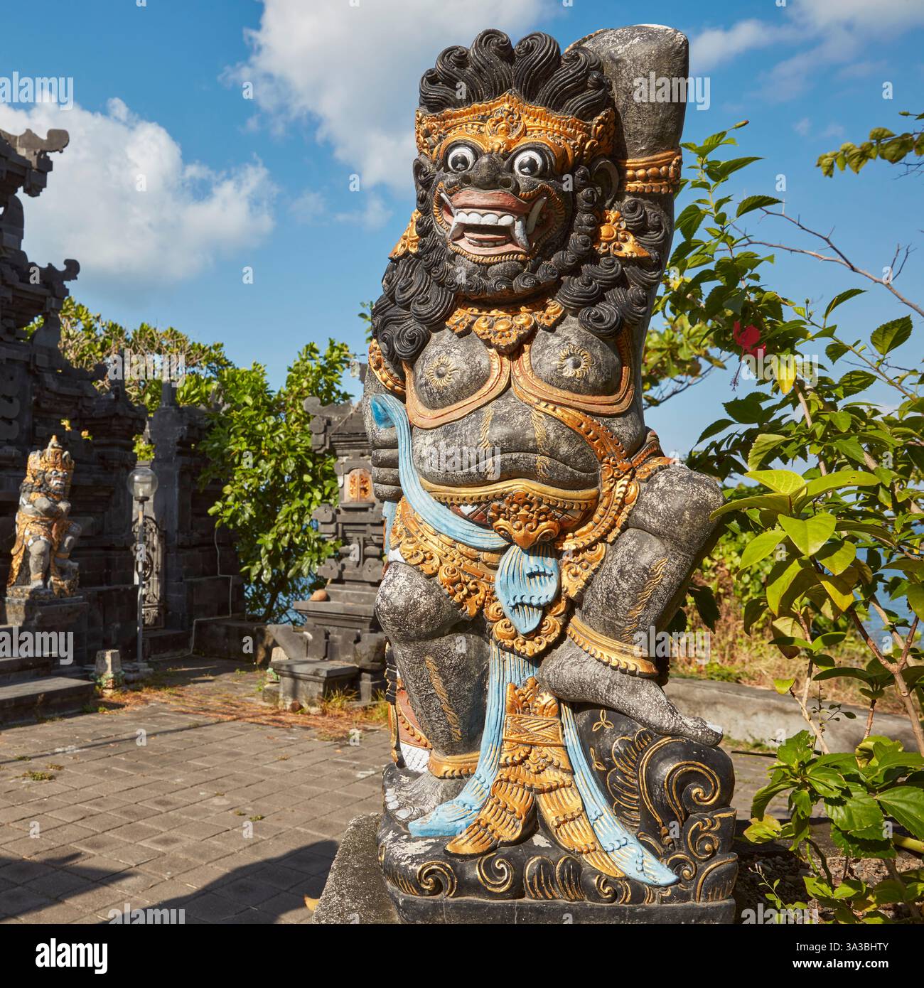 Intricately carved stone statue of a guardian at Batu Mejan Temple ...