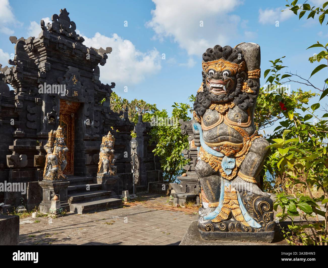 Intricately carved stone statue of a guardian at Batu Mejan Temple ...
