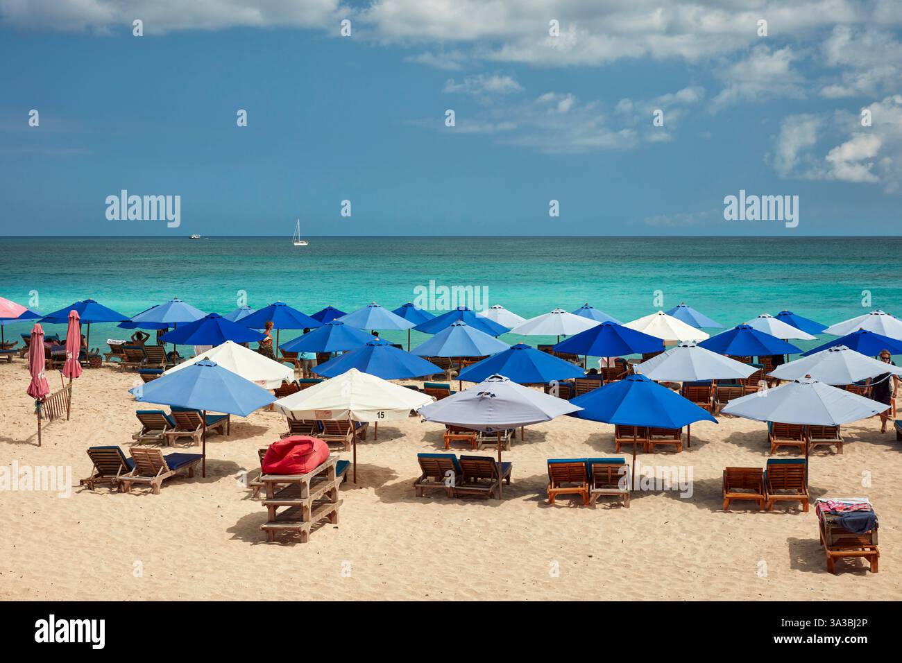Elevated view of Dreamland Beach with many lounge chairs and parasols for rent. Bukit peninsula ...