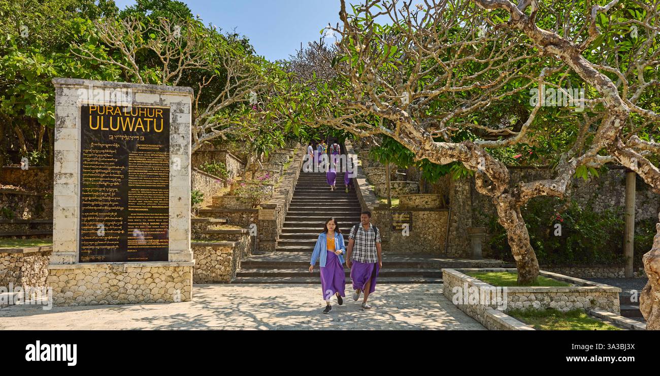 Visitors wearing sarongs walk in the garden at Uluwatu Temple (Pura ...