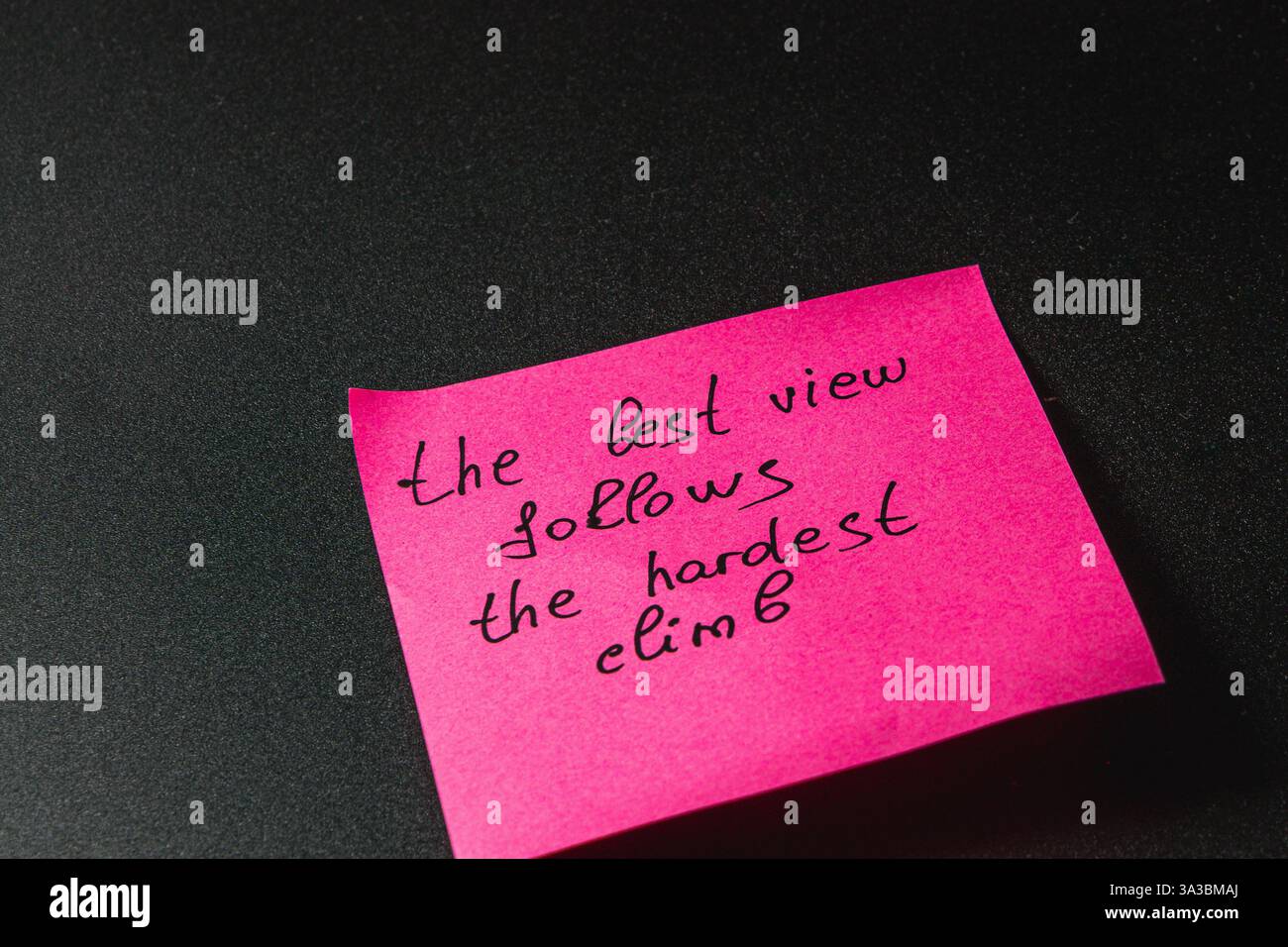 A pink sticky note displays an inspiring message about overcoming ...