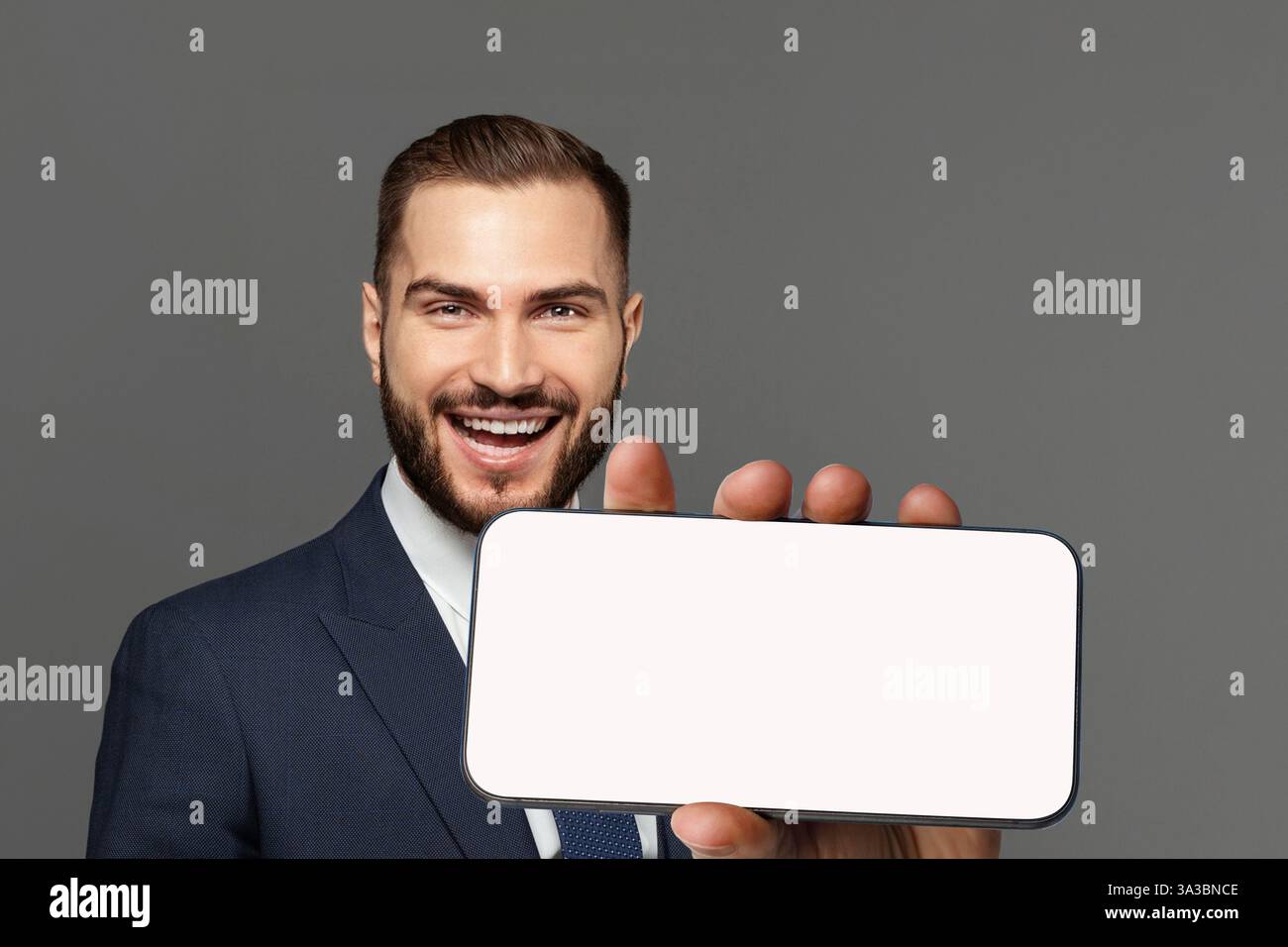 Portrait of successful businessman on grey studio wall background with ...