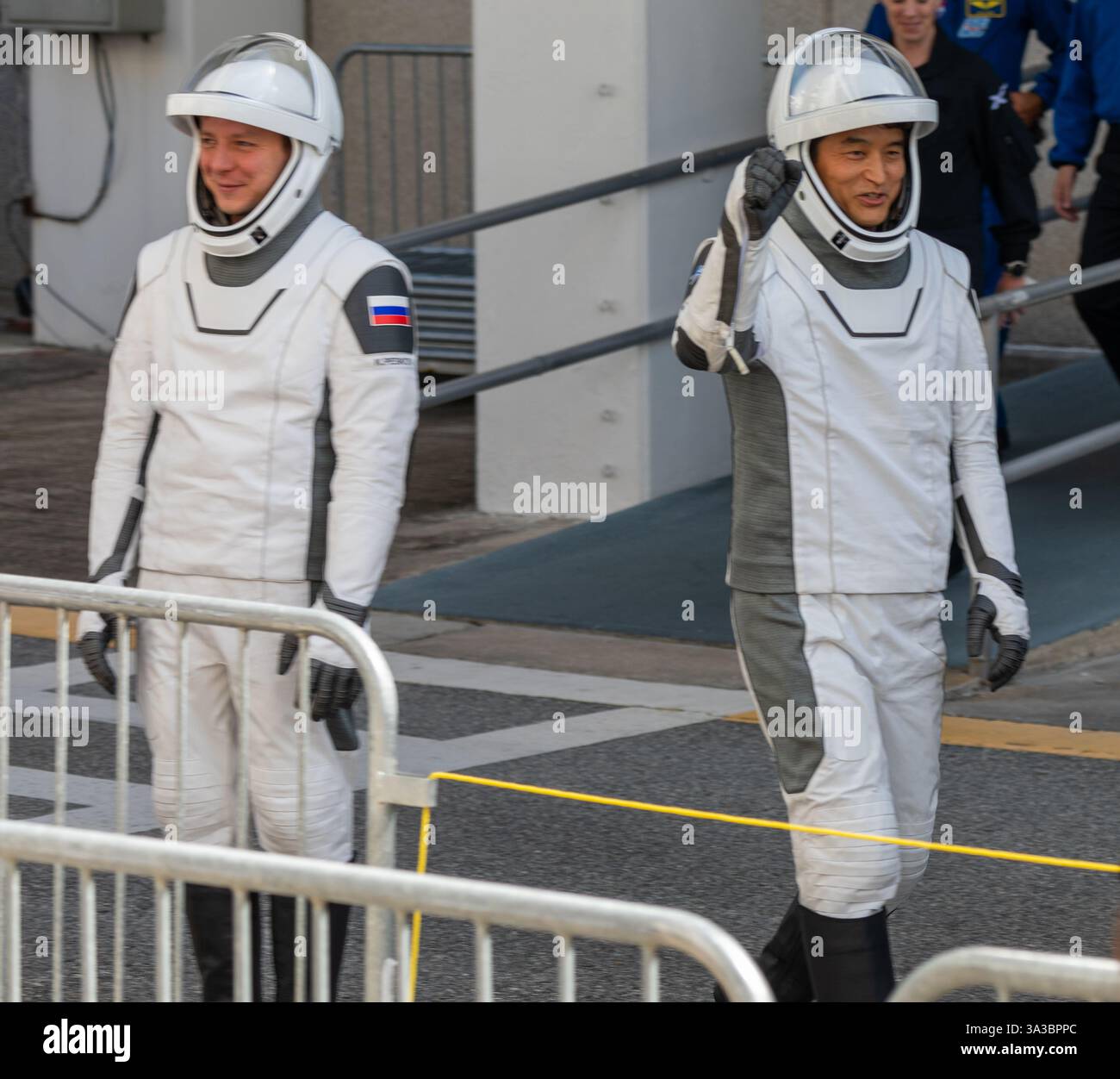 Excitehed astronauts walking out of the Neil Armstrong O & C Building ...