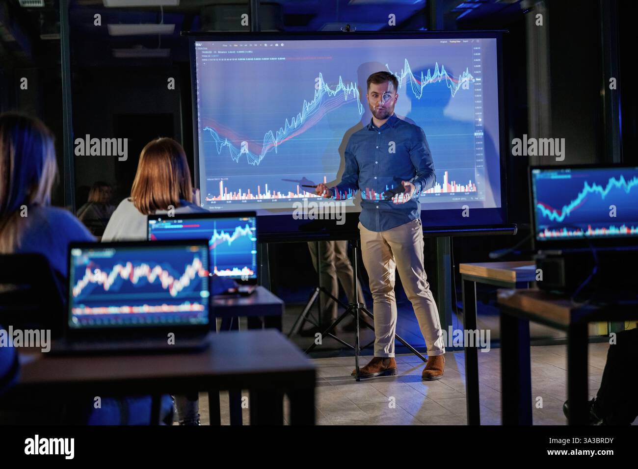 Graph is going up. Male business trainer is against projector with data ...