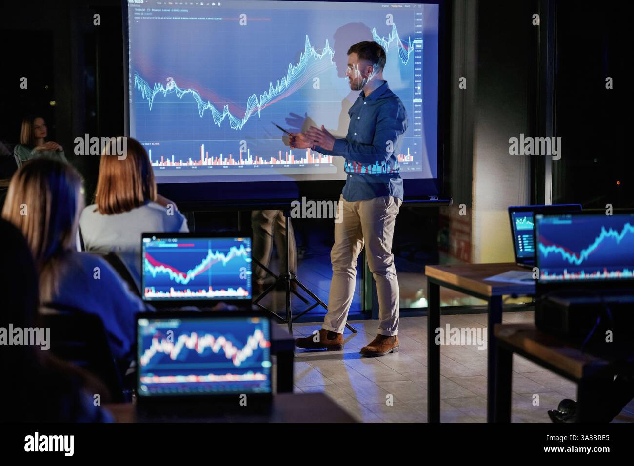 Graph is going up. Male business trainer is against projector with data ...
