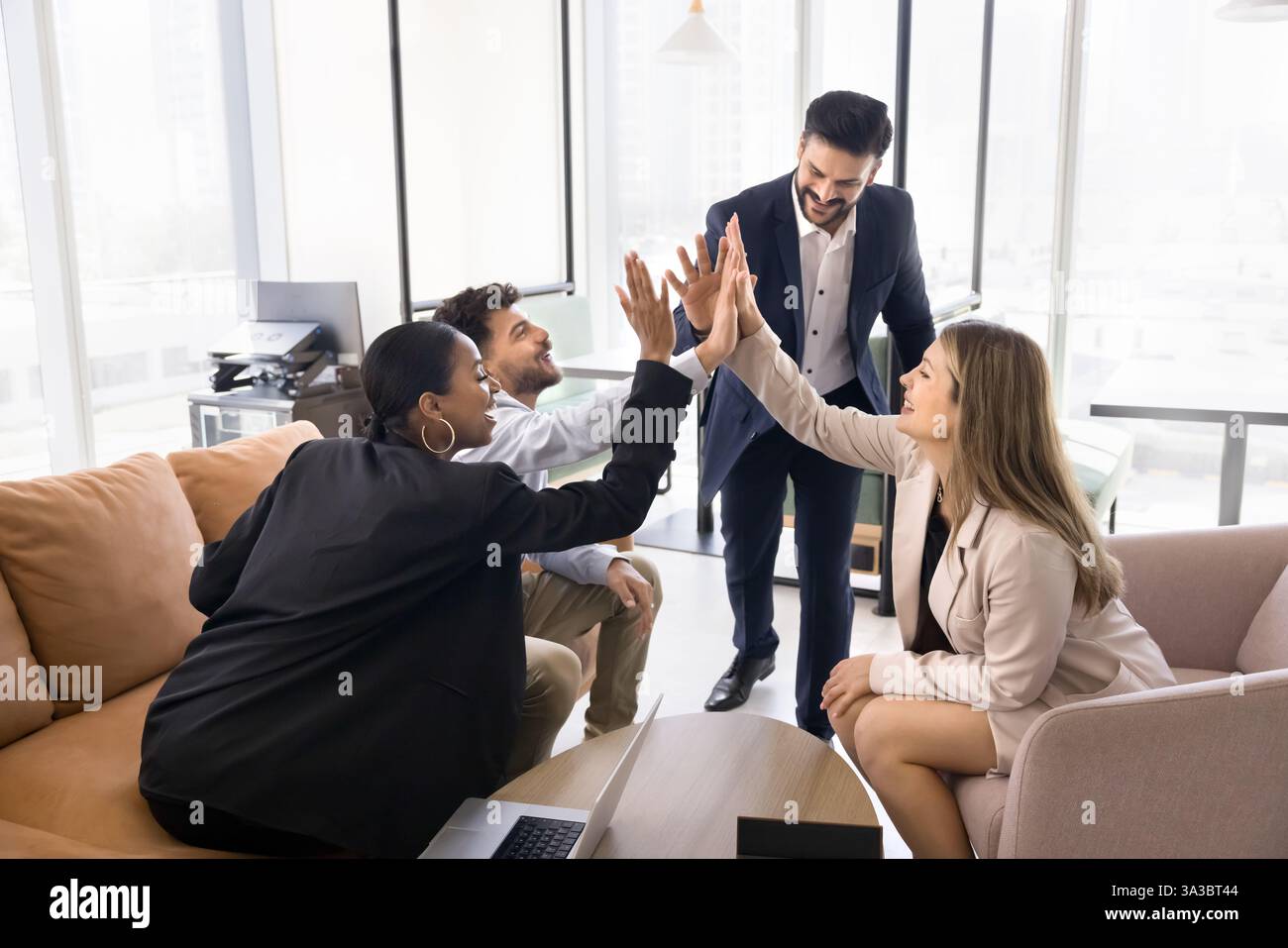 Four multinational teammates giving high five gesture of unity Stock ...