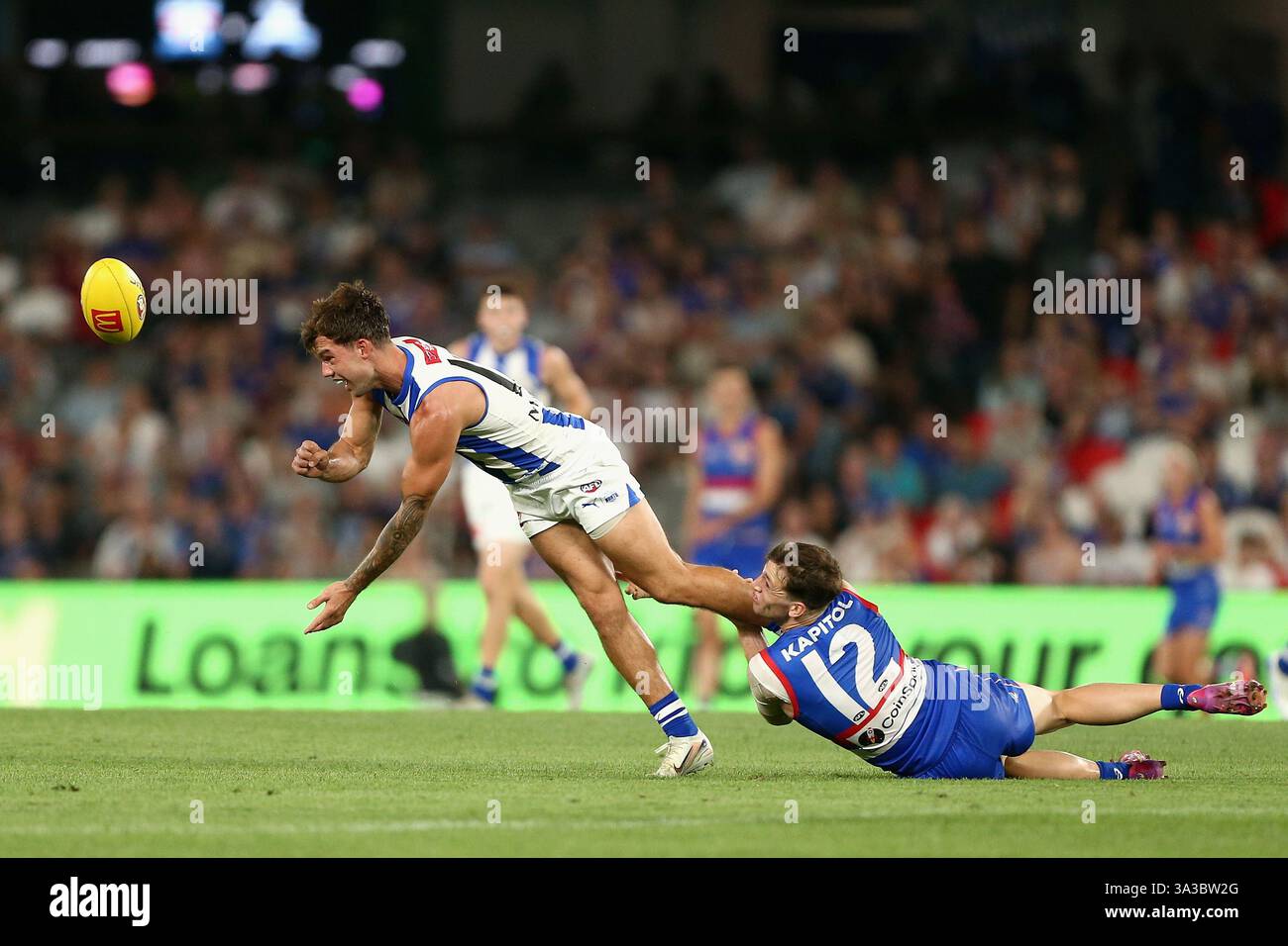 Jy Simpkin of the Kangaroos handballs during the AFL Round 1 match ...