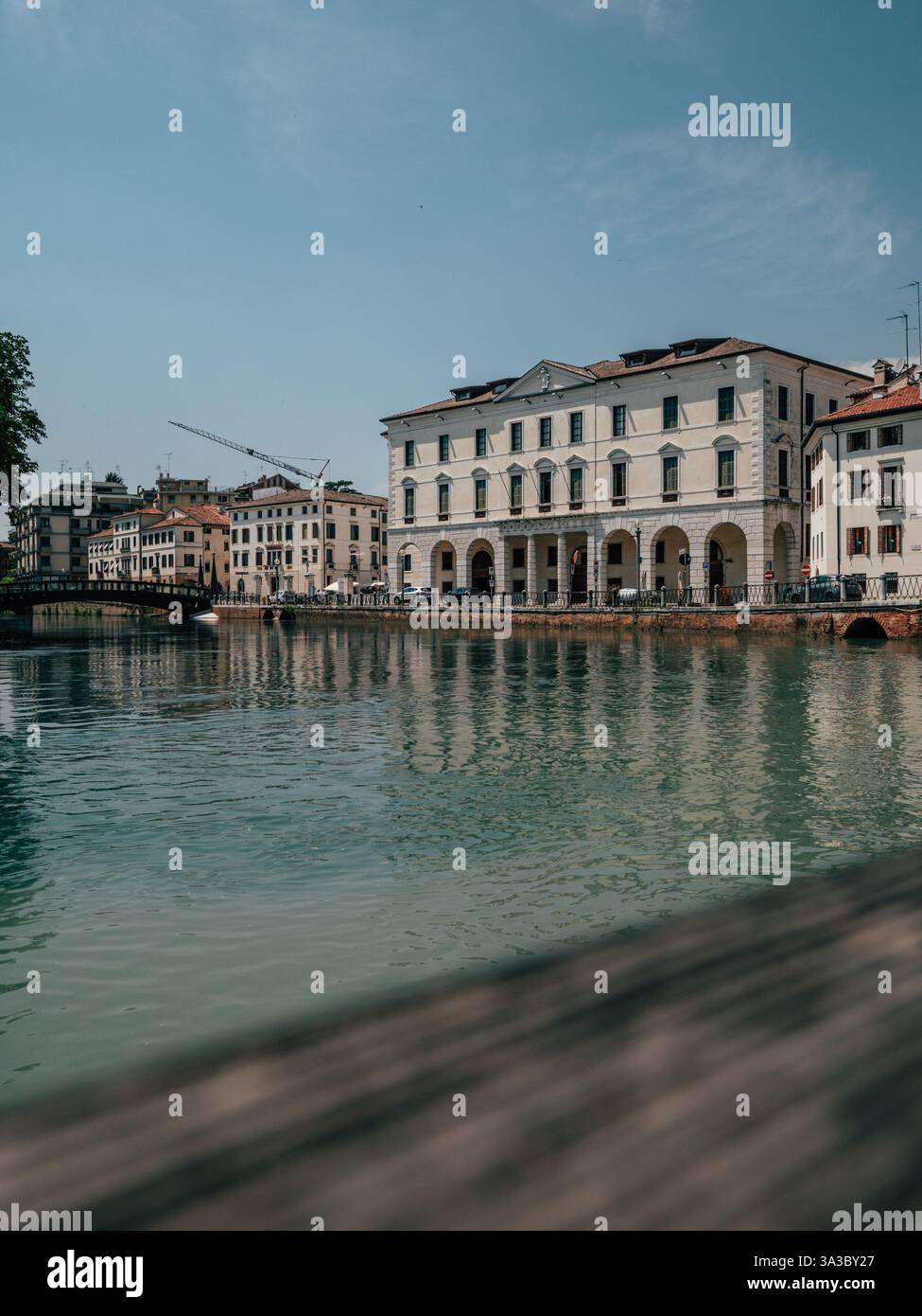 Visitors enjoy the tranquil ambiance of Treviso, Italy, surrounded by ...